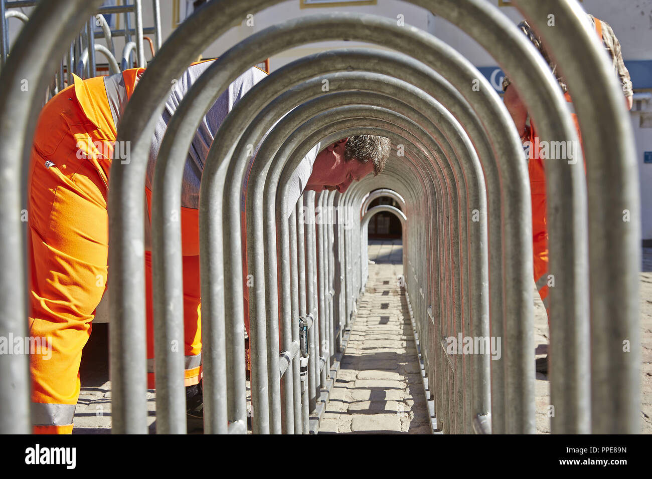 Employees of the city mount bike racks in the Marktstrasse in Bad Toelz ...