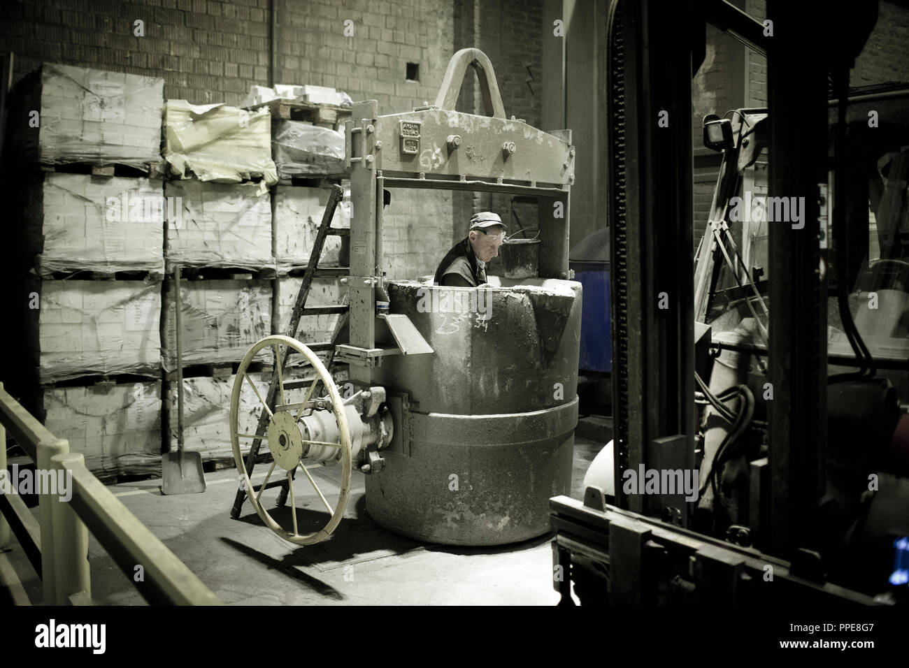 Worker casting a marine diesel engine Stock Photo - Alamy
