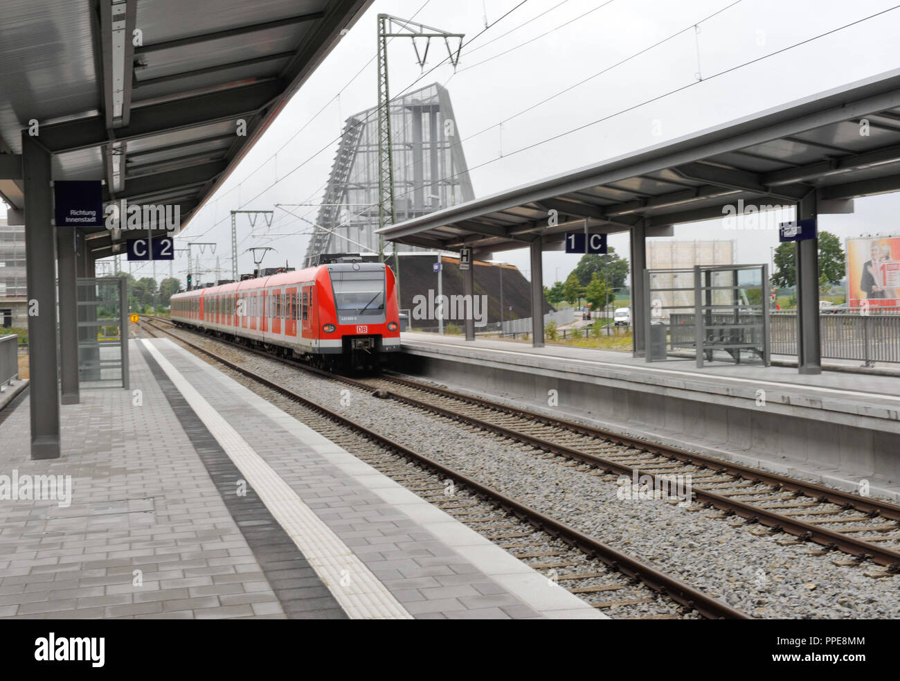 Incoming train in the Freiham S-Bahn station Stock Photo - Alamy