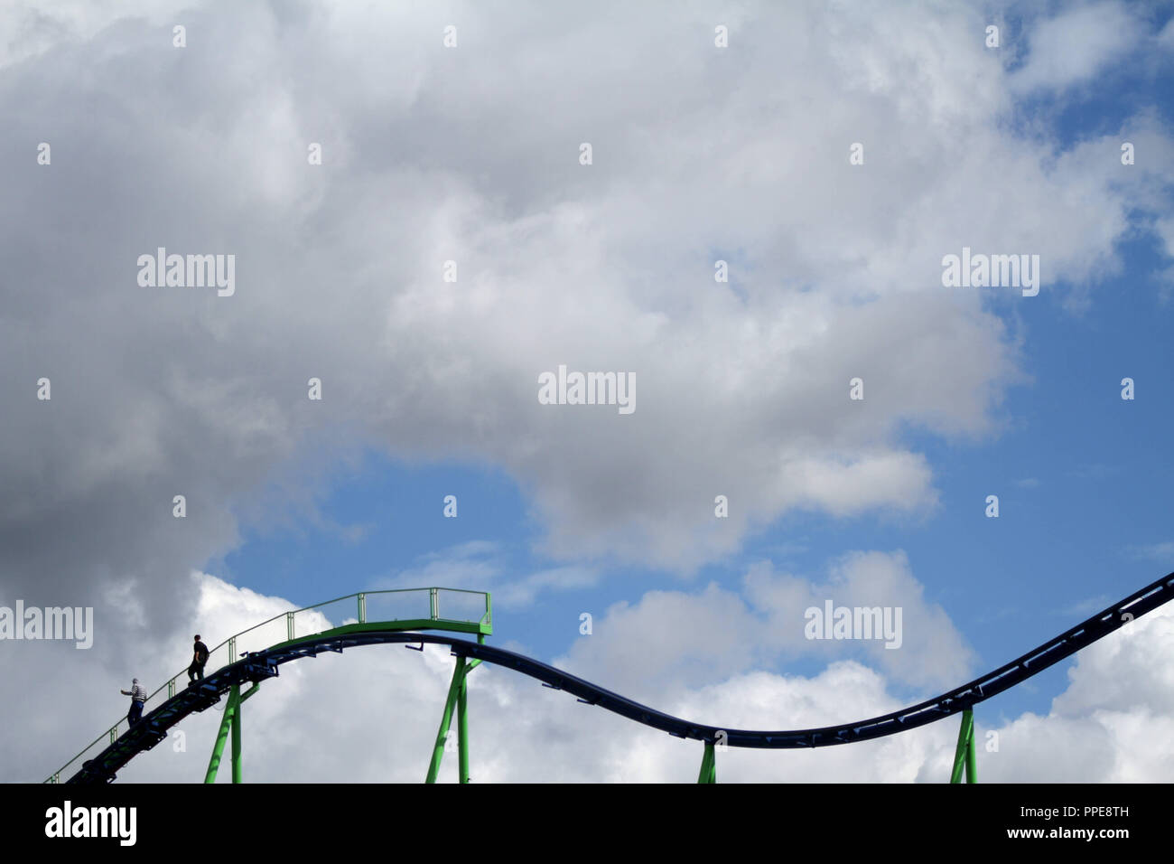 Workers in dizzy height building a roller coaster for the Wiesn 2013 ...