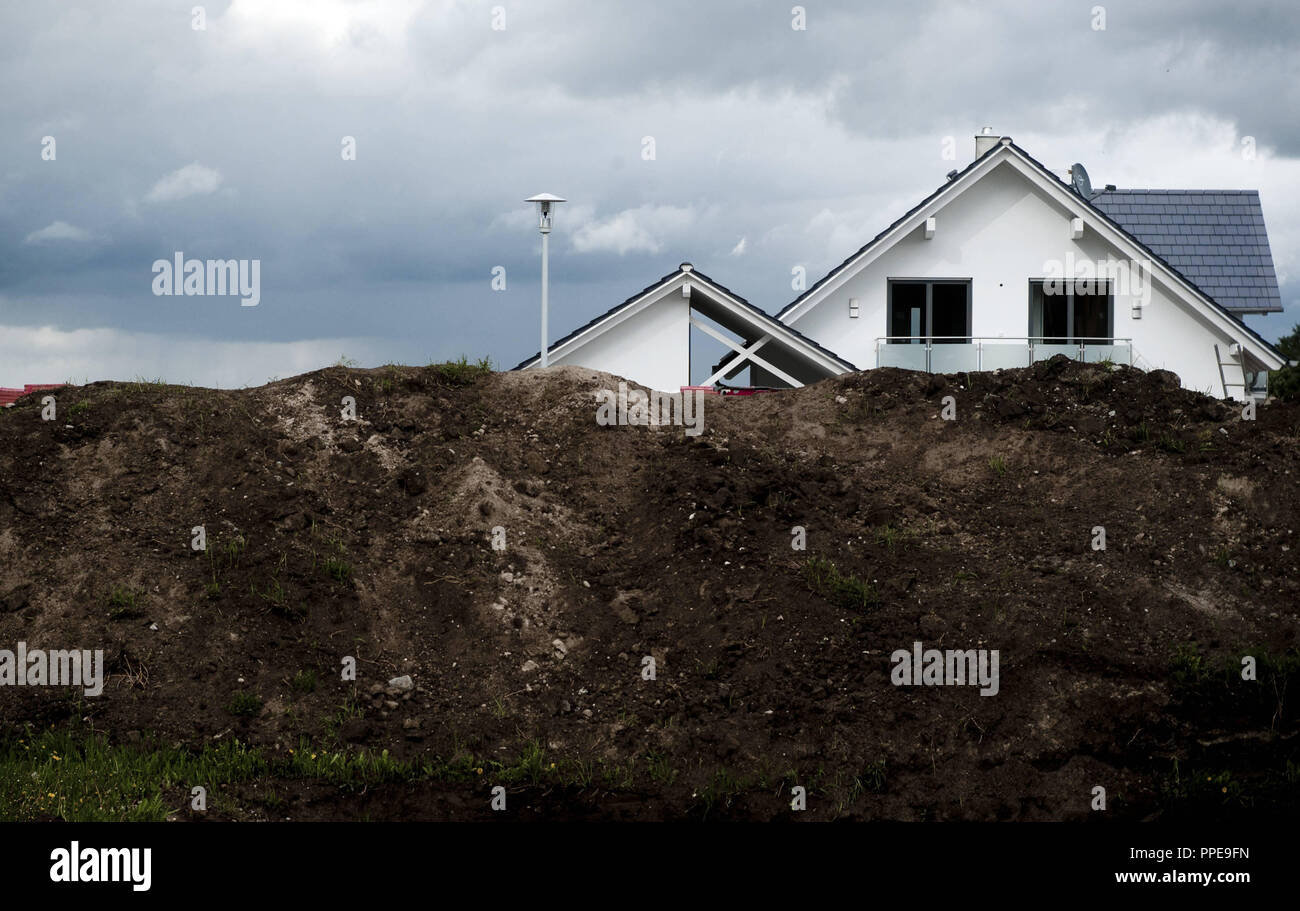 New building with earth wall in the development area at the ...