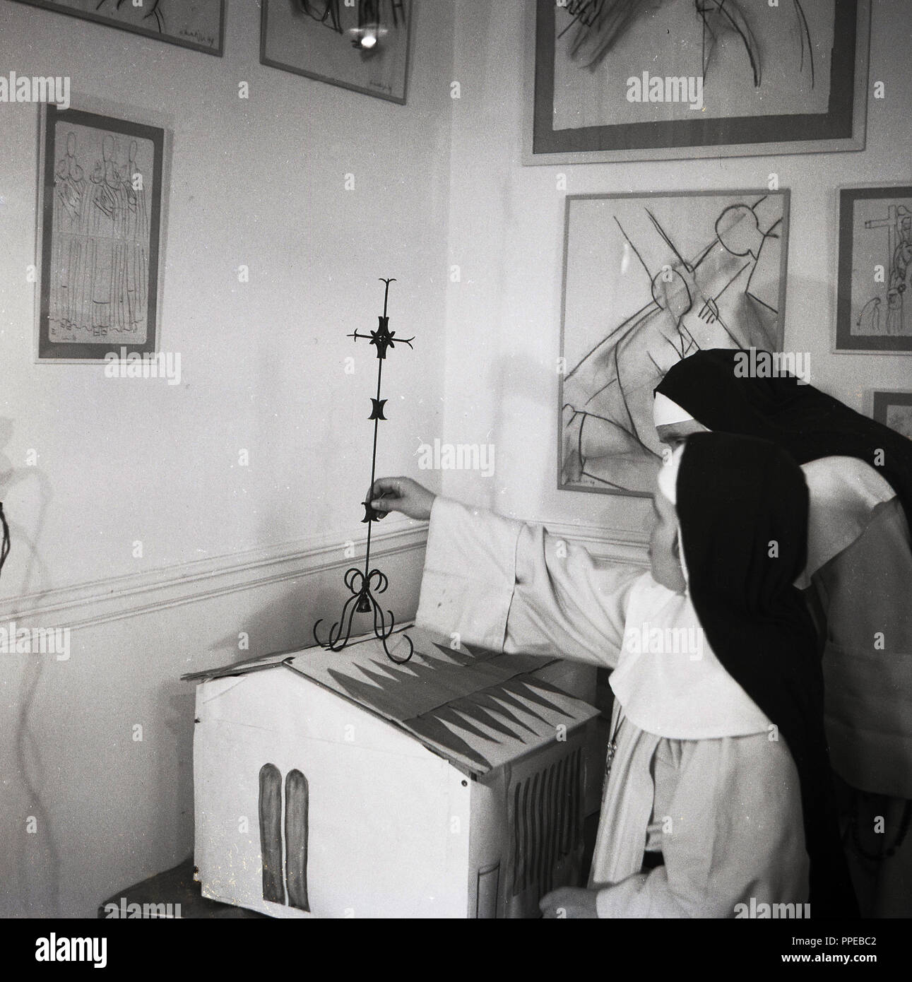 1950, two catholic nuns in a room with sketches on the walls and with a ...