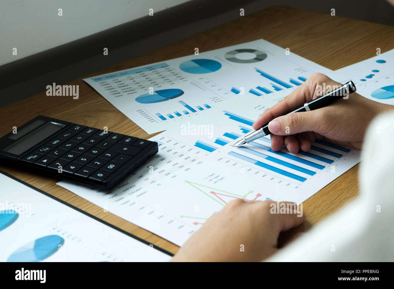 Businessmen are pointing numbers, graph, chart in business results ...