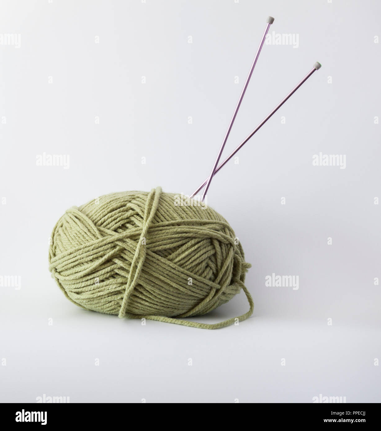 Ball of wool with knitting needles hi-res stock photography and images ...