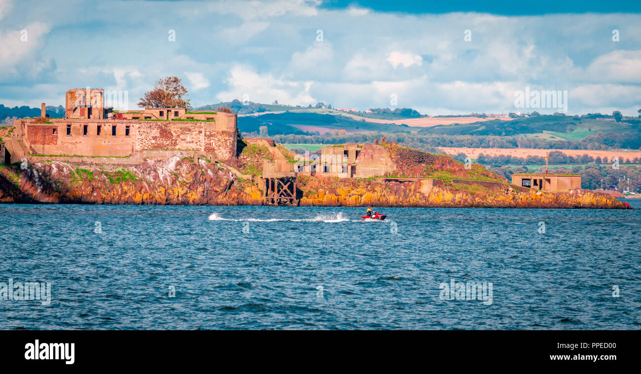 Jet ski going past Inchgarvie island at firth of forth Stock Photo - Alamy