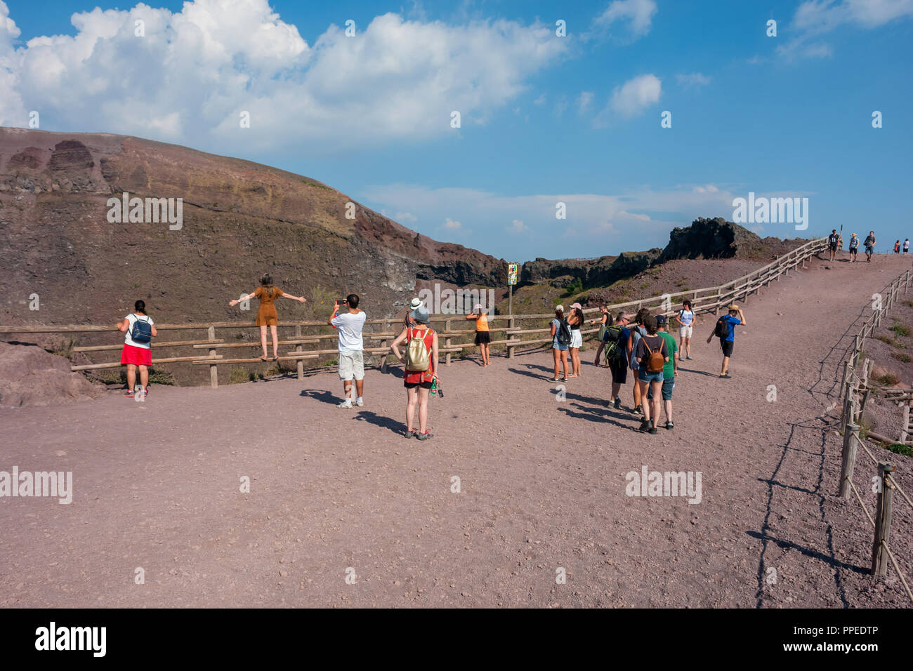 MOUNT VESUVIUS, ITALY - AUGUST 1, 2018: Tourists walk around the crater ...