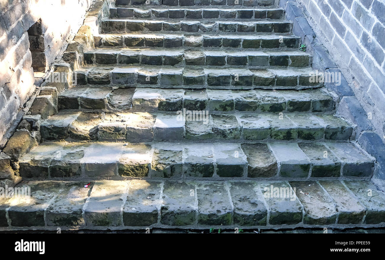 Old gray concrete steps on the ancient wall. It’s stone step to the ...