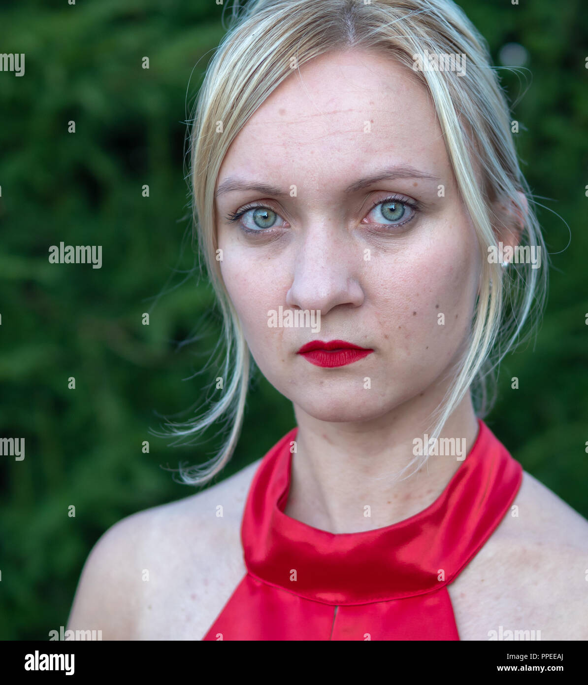 Naturally beautiful millennial woman in sexy red dress Stock Photo - Alamy