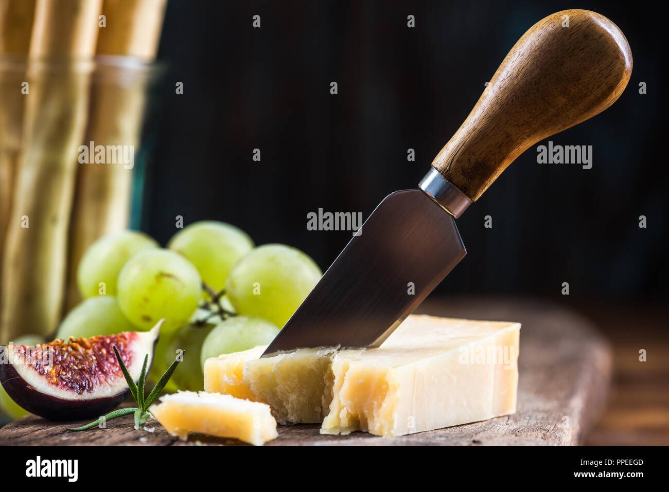 Parmesan cheese pieces cut by cheese knife Stock Photo - Alamy
