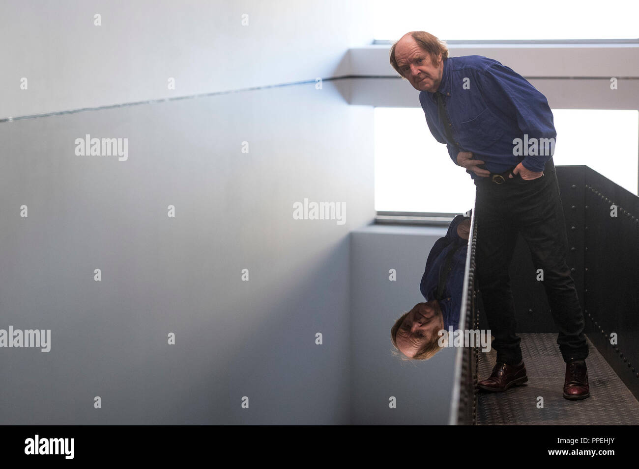 Artist Richard Wilson with his piece '20:50, 1987', made with slump oil ...