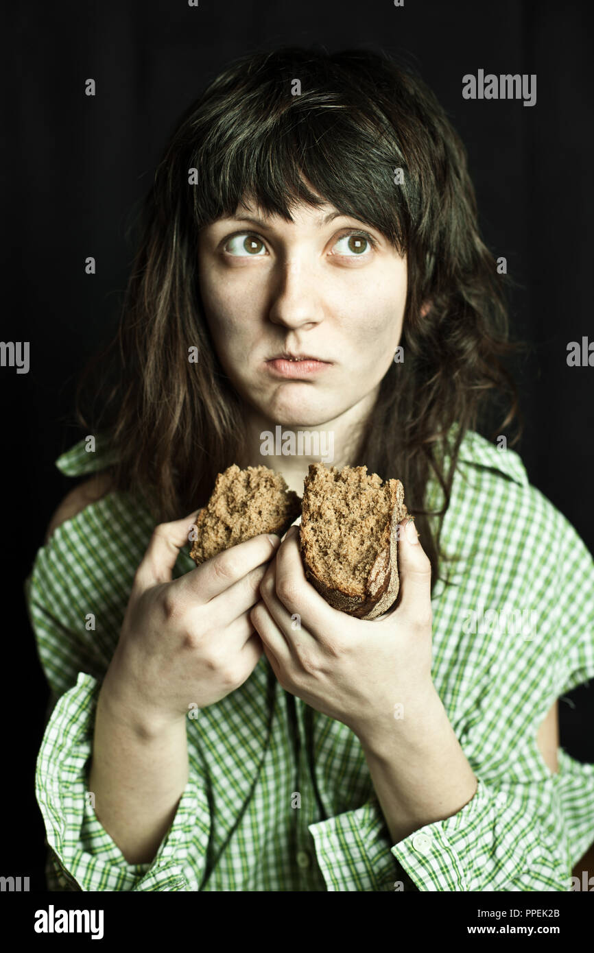 Beggar woman eating bread hi-res stock photography and images - Alamy