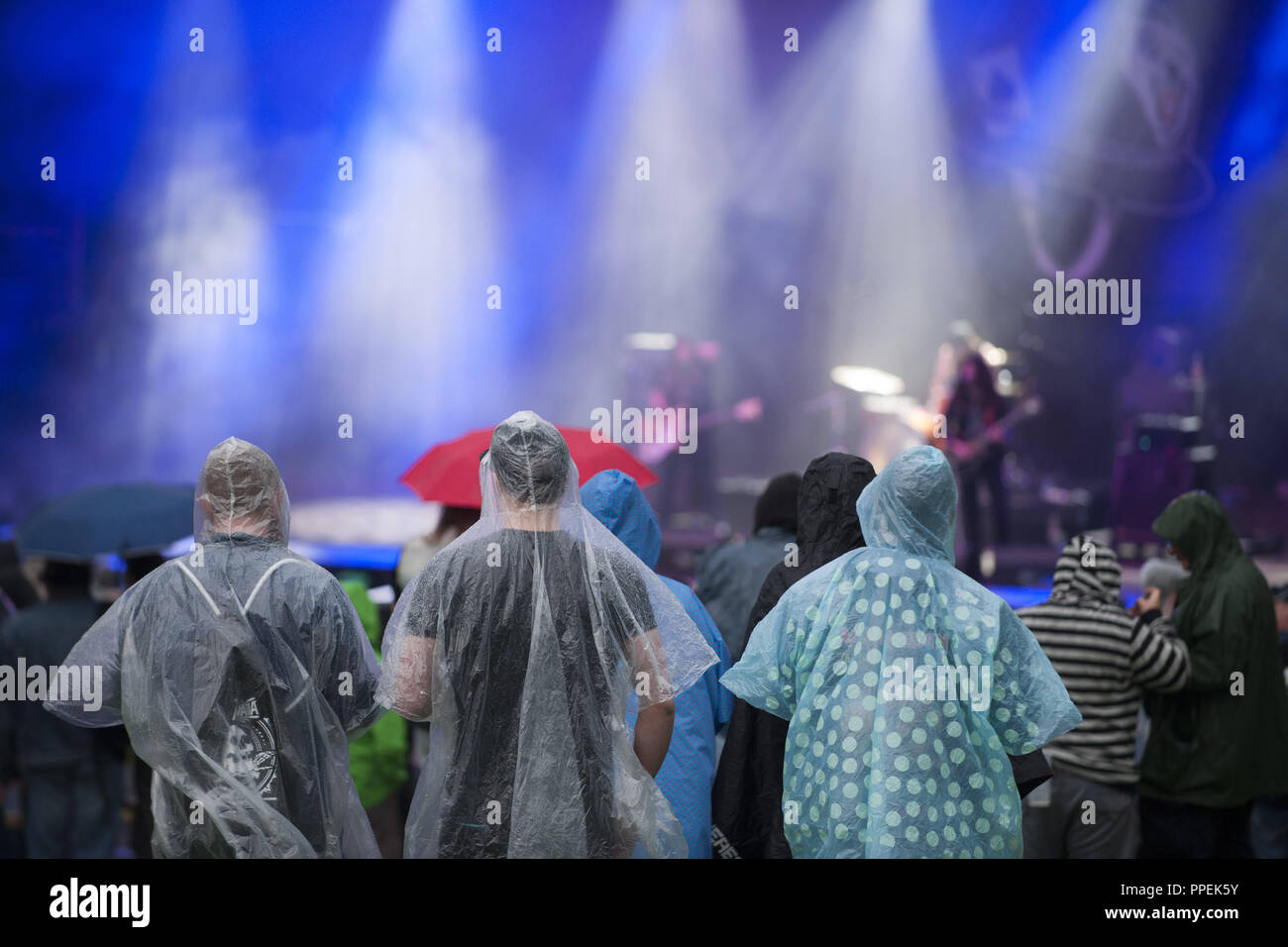 Audience in the rain during the performance of the band "The Shrine" at ...