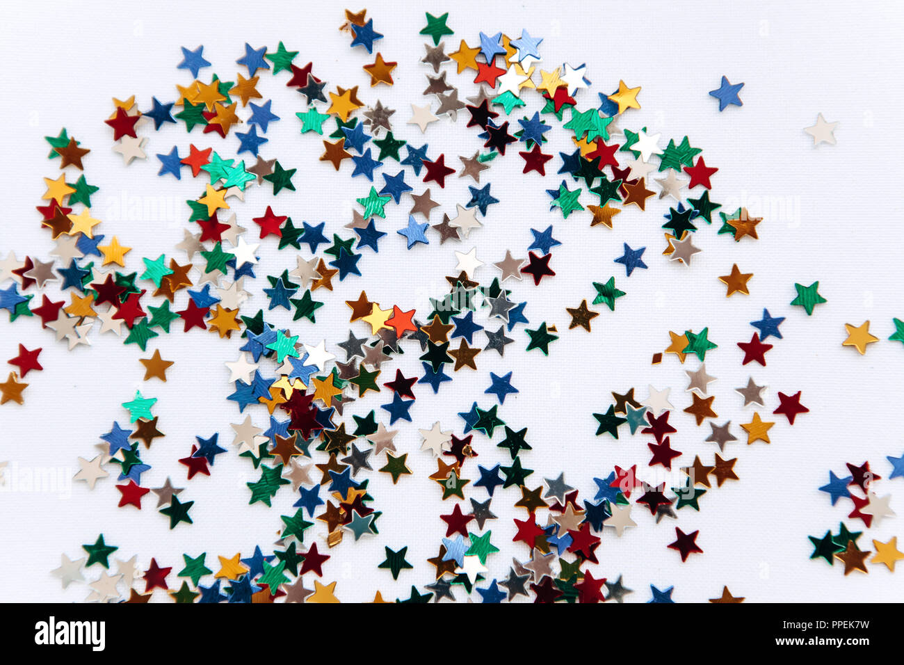 Festive colorful stars of confetti on a white background Stock Photo ...