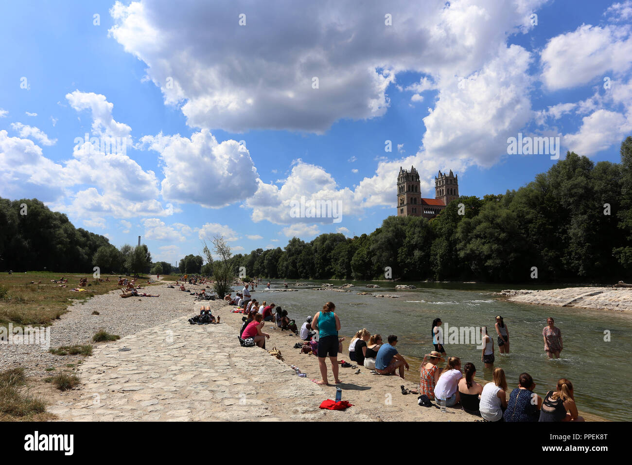 Citizens of Munich enjoy a warm summer day at the river Isar below the ...