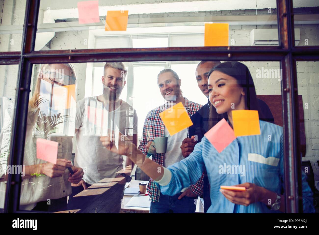 Business people meeting at office and use post it notes to share idea ...