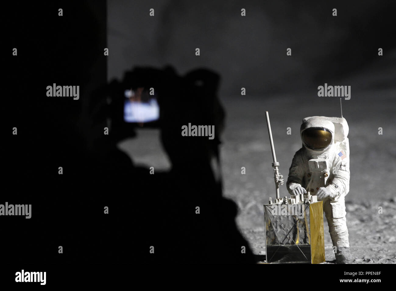 Visitors in front of a display case showing the first moon landing in ...