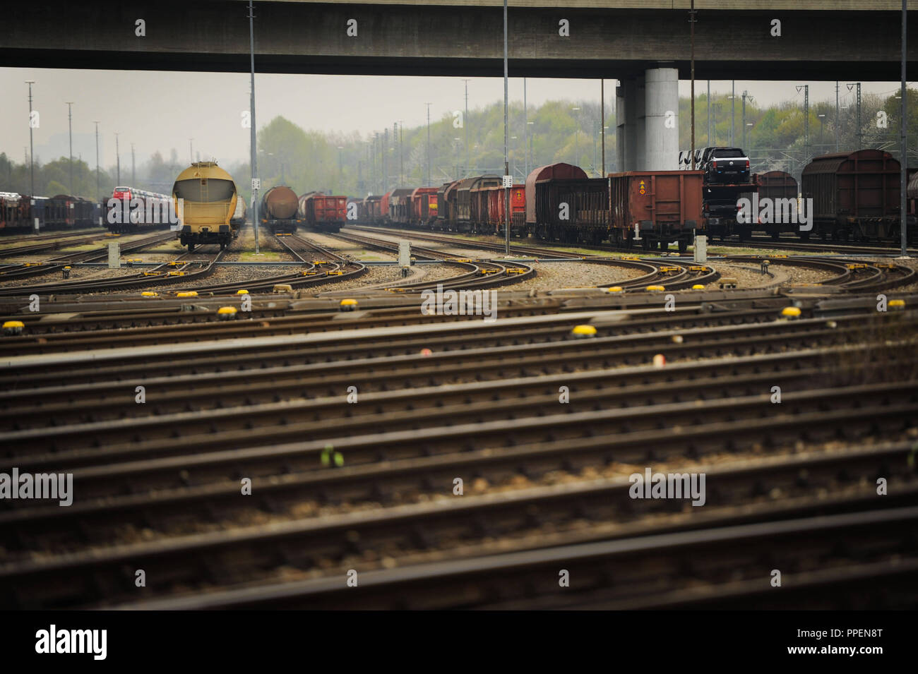 Trains and tracks under a bridge at the marshalling yard in Munich ...