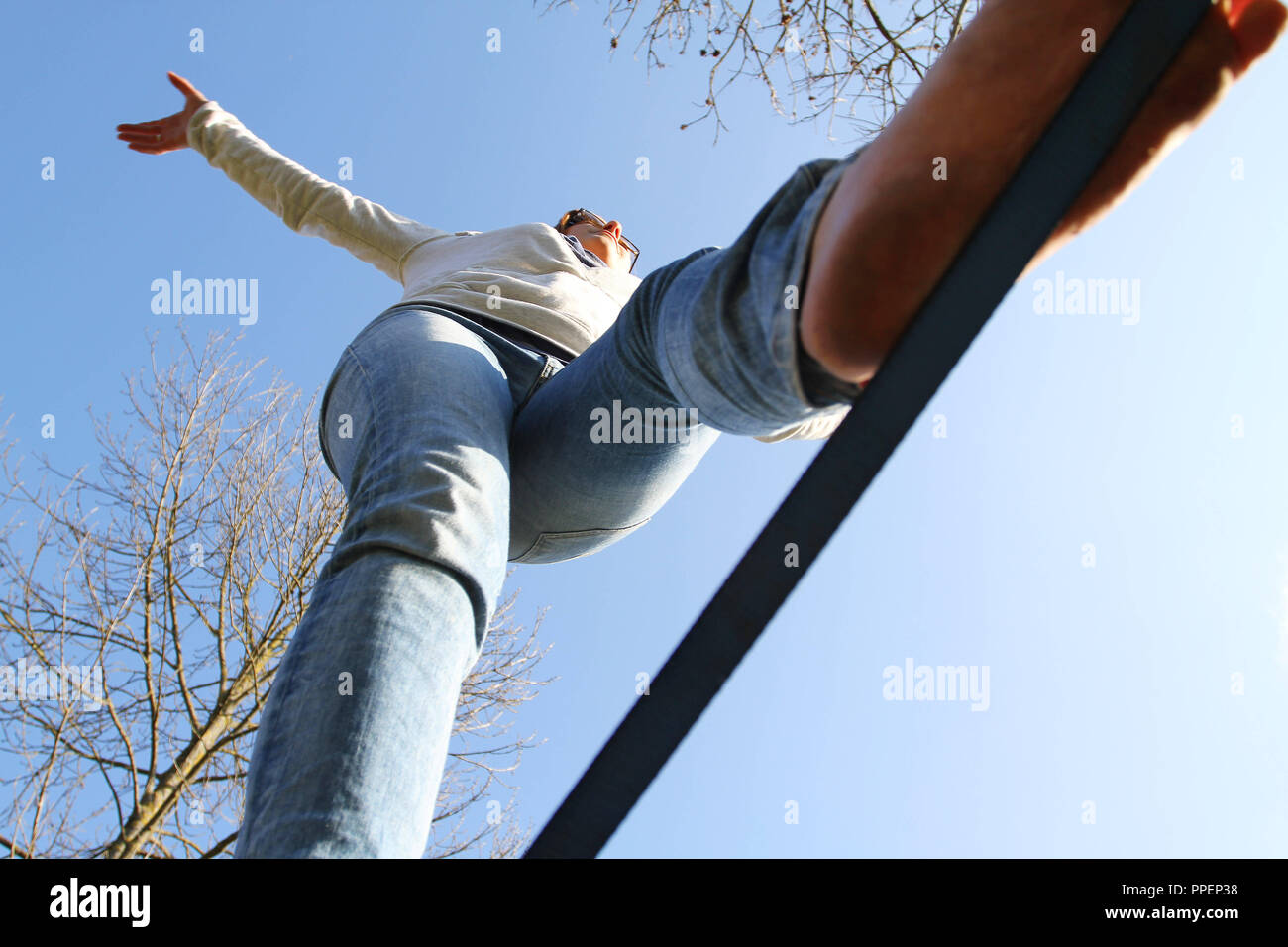 Woman balancing on slackline hi-res stock photography and images - Alamy