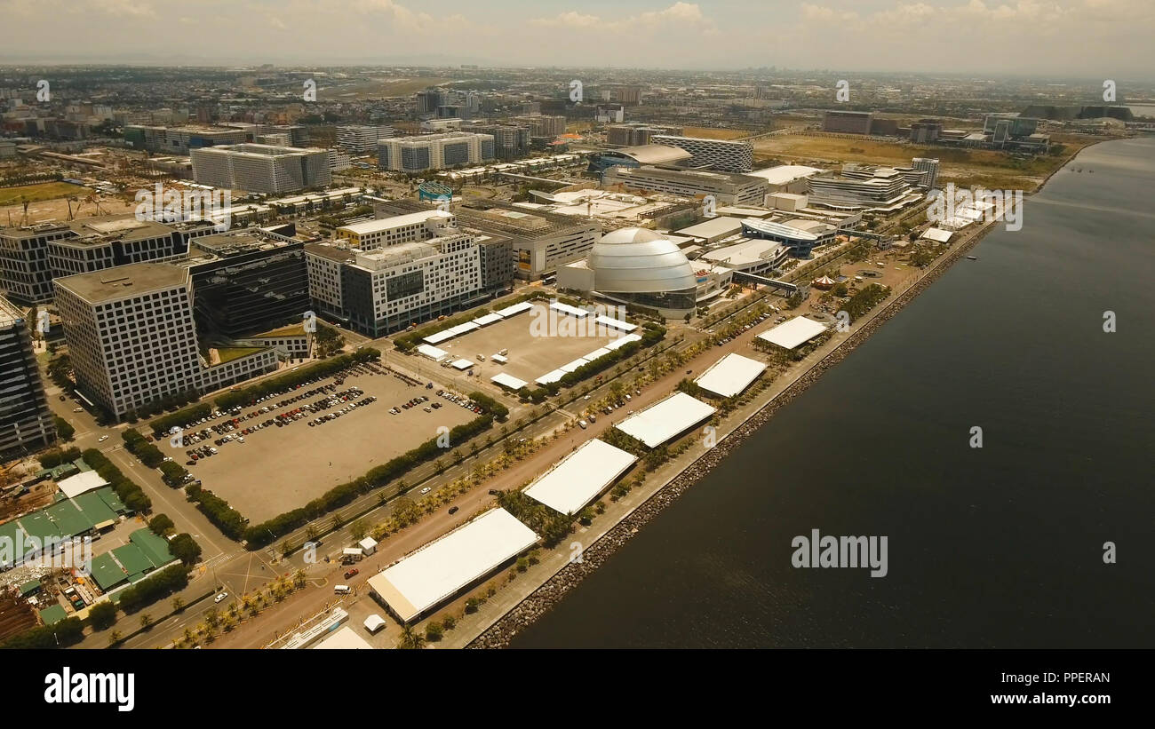 Aerial view of Manila city. Fly over city with skyscrapers and ...