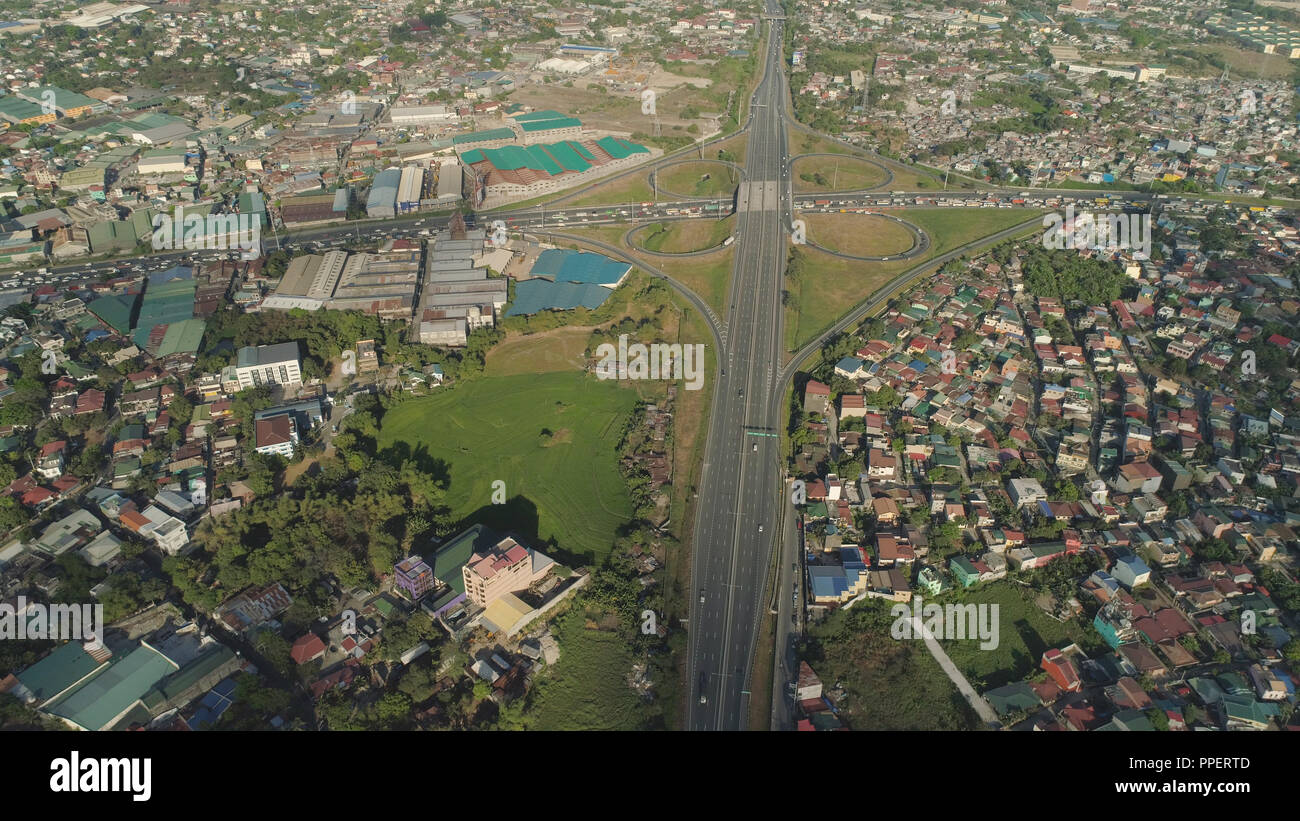 Aerial view of highway with road junction, car and traffic in Manila ...