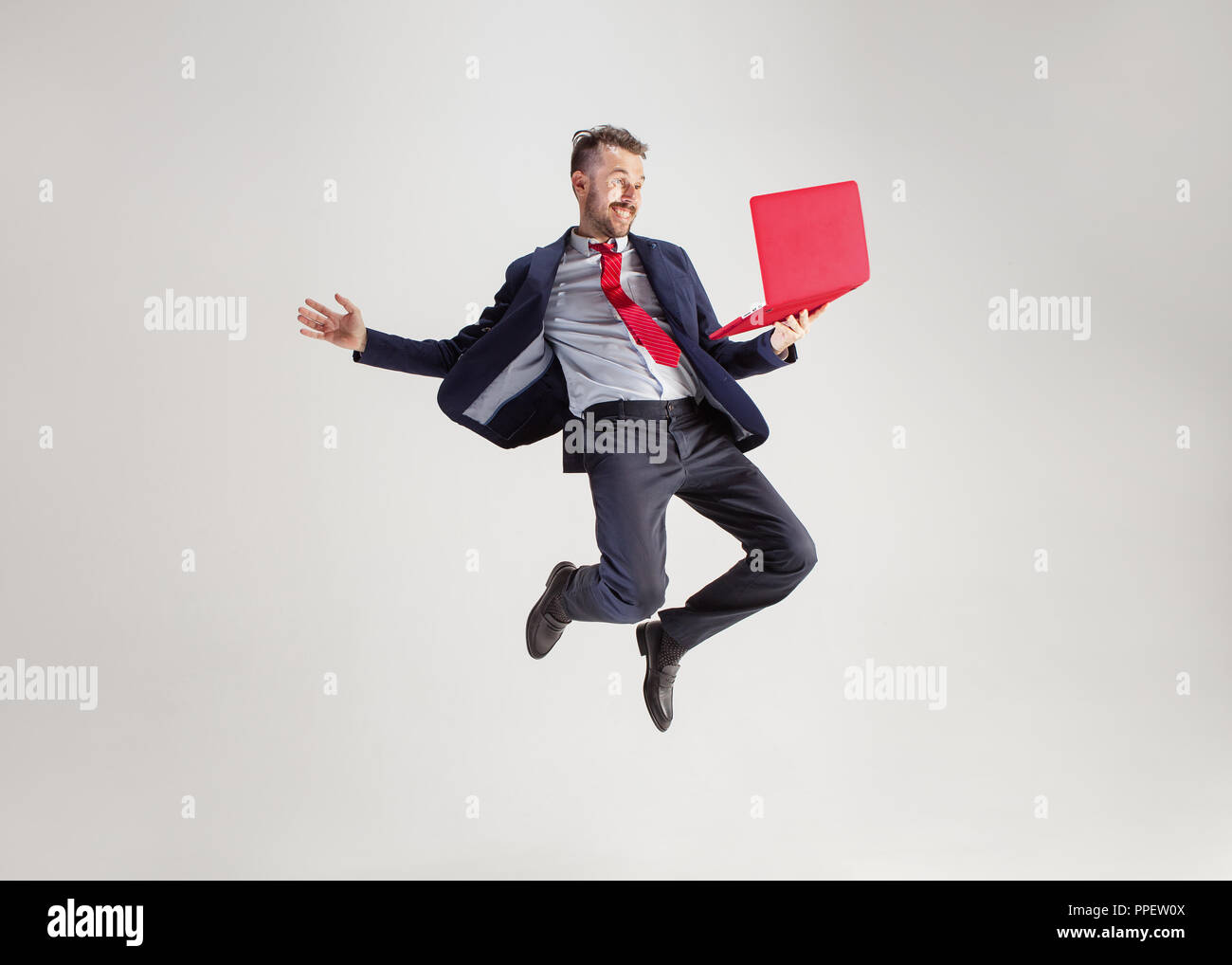 Image of young surprised man over white studio using laptop computer ...