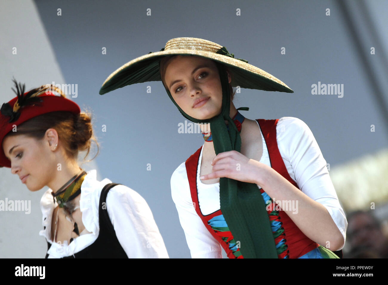 Model with dirndl and fancy straw hat during a fashion show at the ...