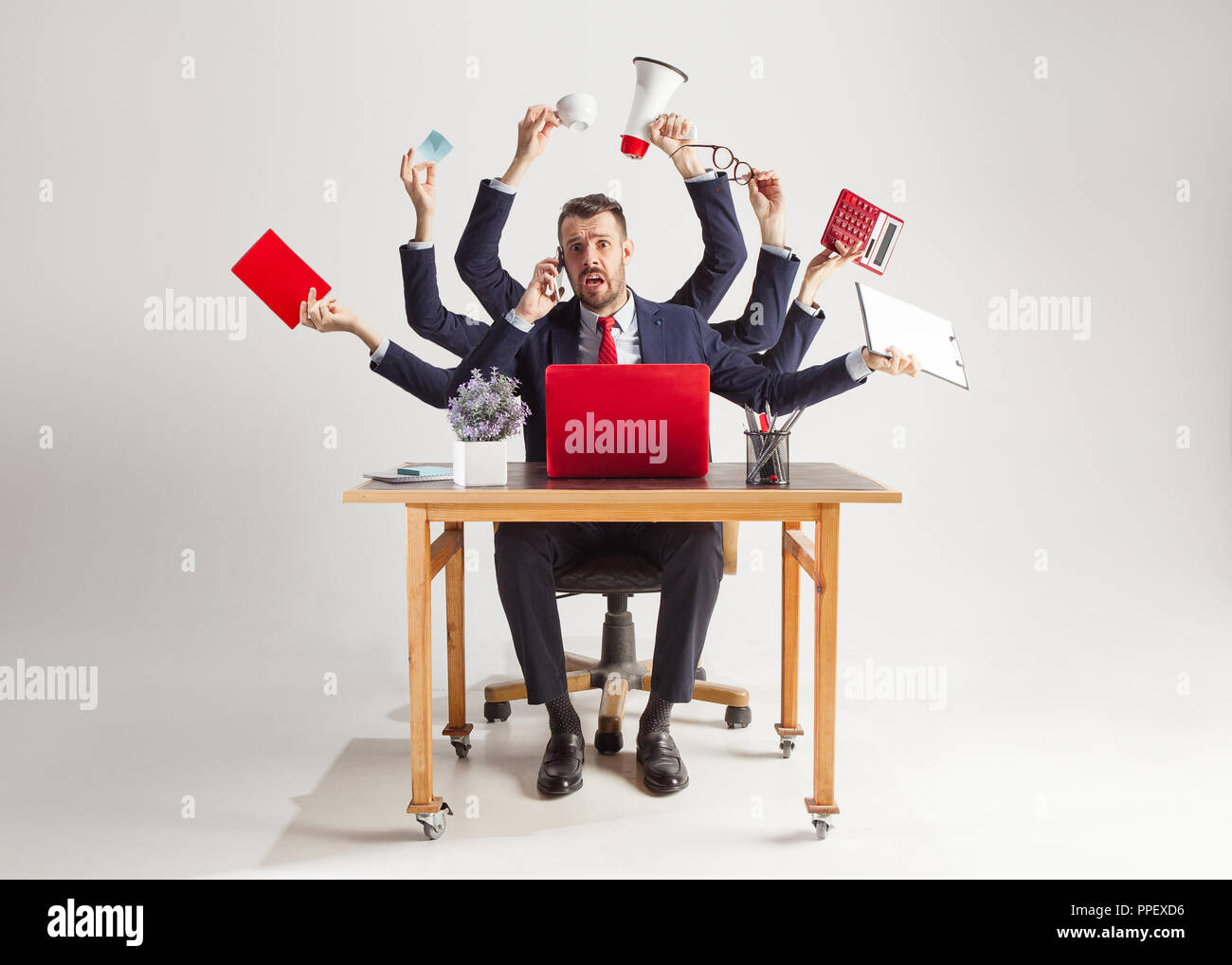 businessman with many hands in elegant suit working and holding office ...