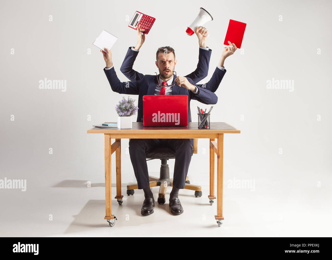 businessman with many hands in elegant suit working and holding office ...