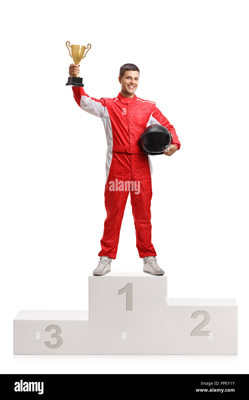Full length portrait of a male racer winner on a winner's pedestal with ...