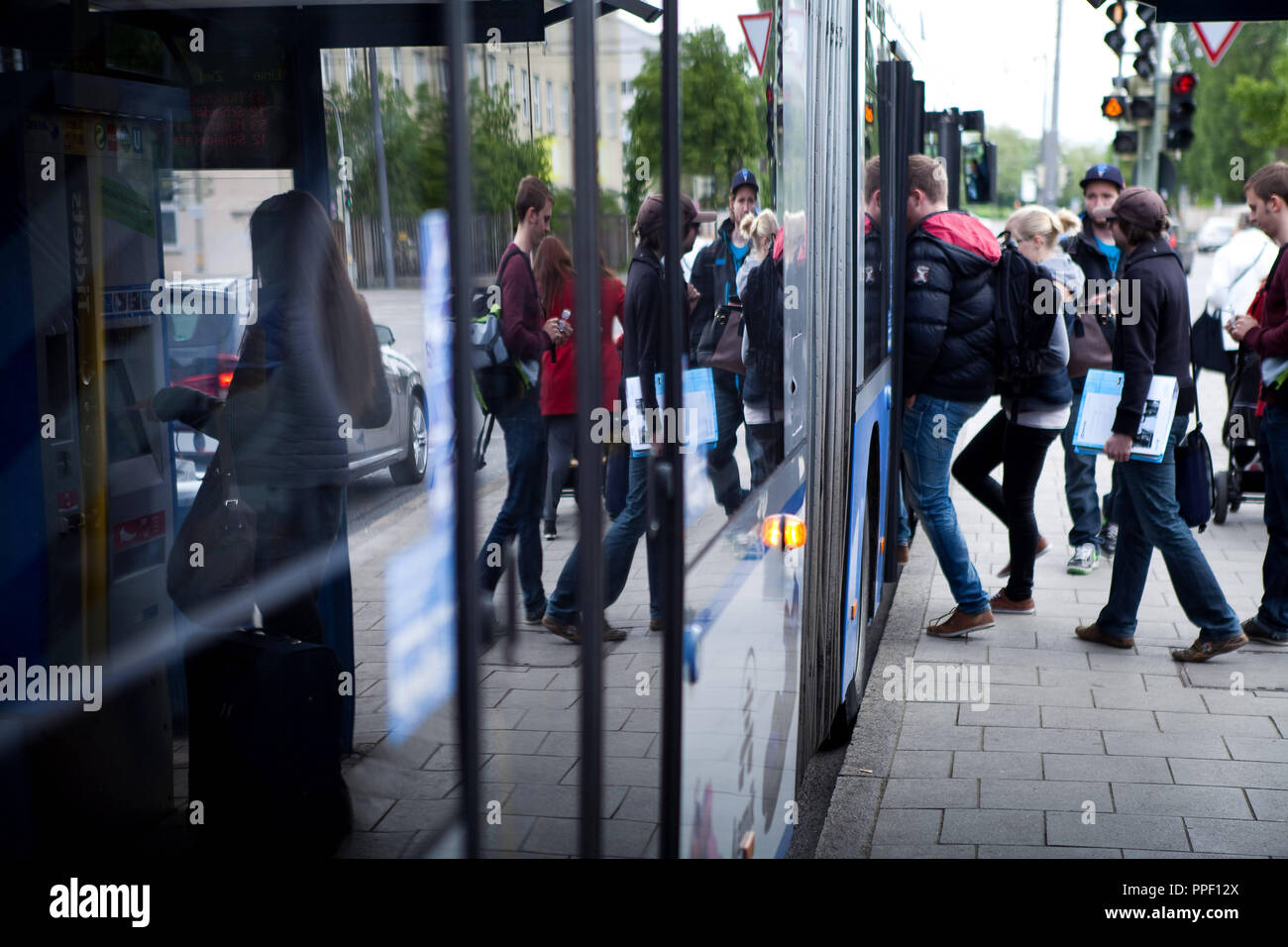 Passengers get on a bus at Leonrodplatz Stock Photo - Alamy