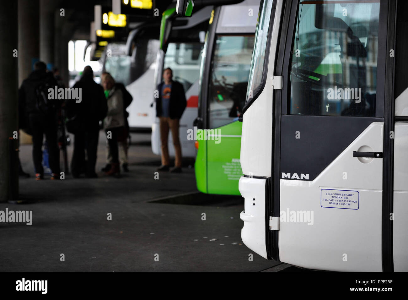 Buses and passengers at the Central Bus Station Munich (ZOB ...