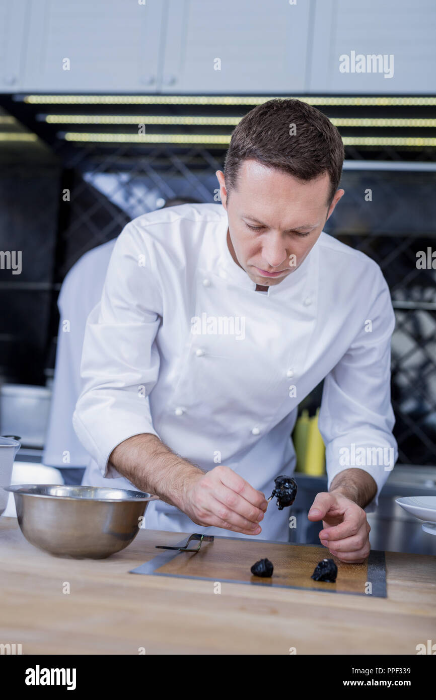 Great cook preparing a delicious dinner for the guests Stock Photo - Alamy