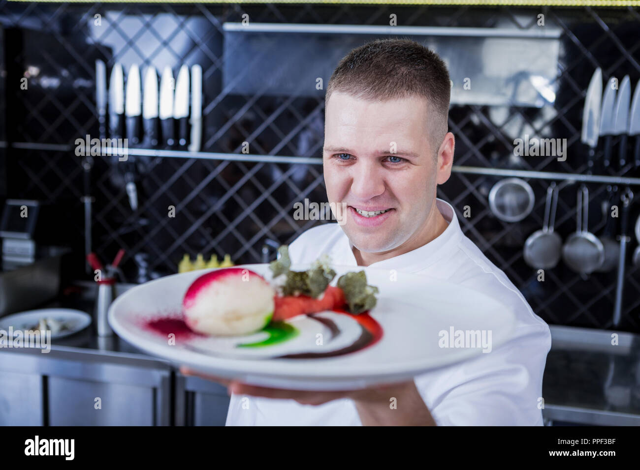 Happy cook introducing a new dessert to others Stock Photo - Alamy