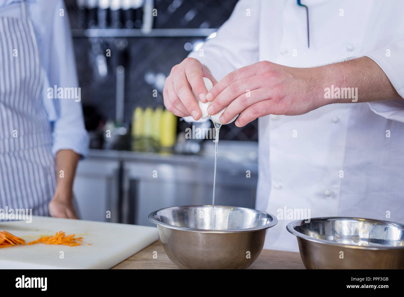 Experienced cook adding some new ingredients to a dish Stock Photo - Alamy