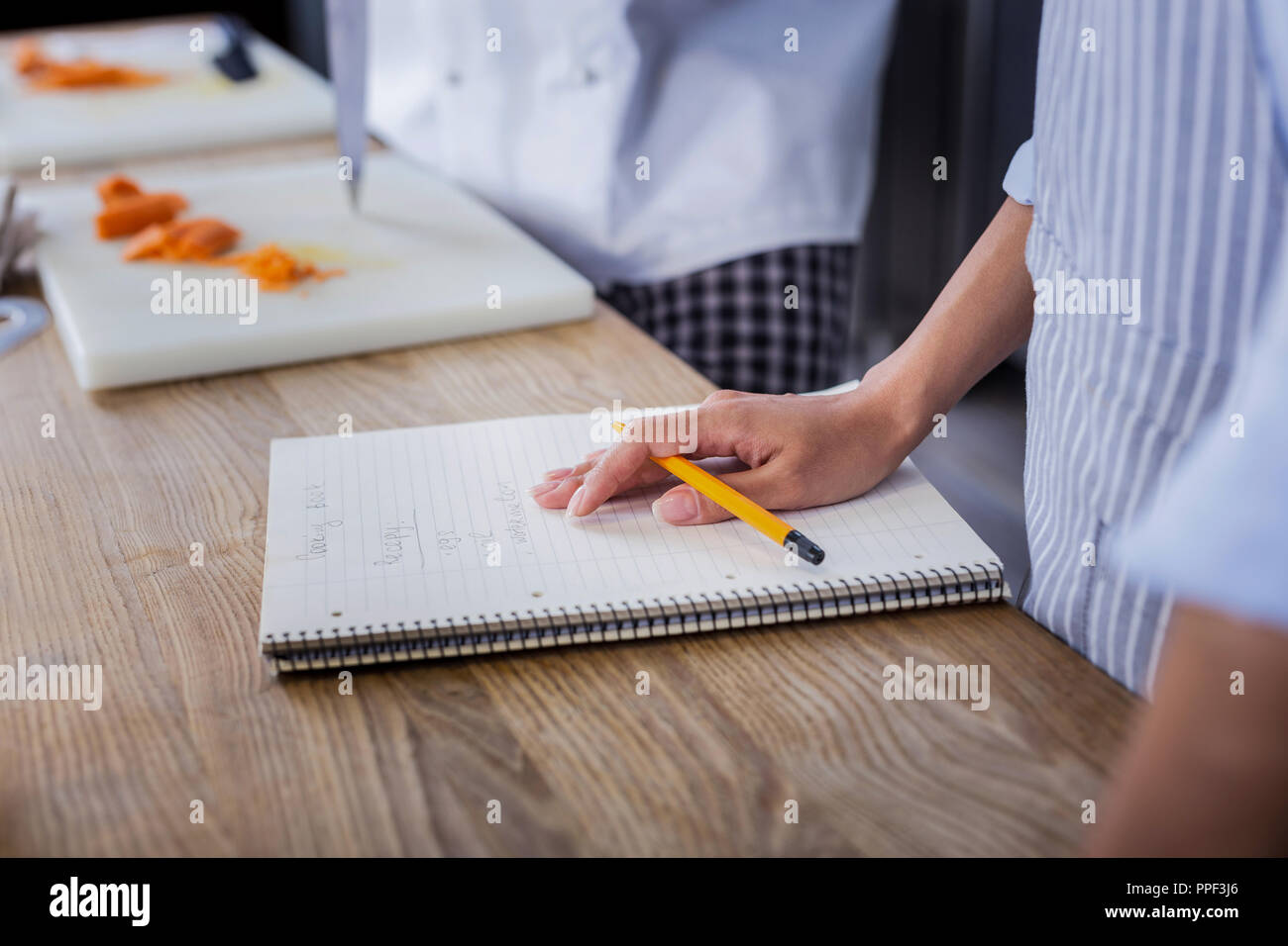 Young lady making important notes in the notebook Stock Photo - Alamy