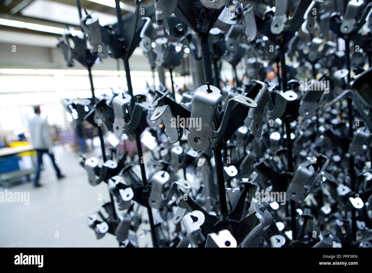 Brackets for engine compartments on racks waiting to be polished in a ...