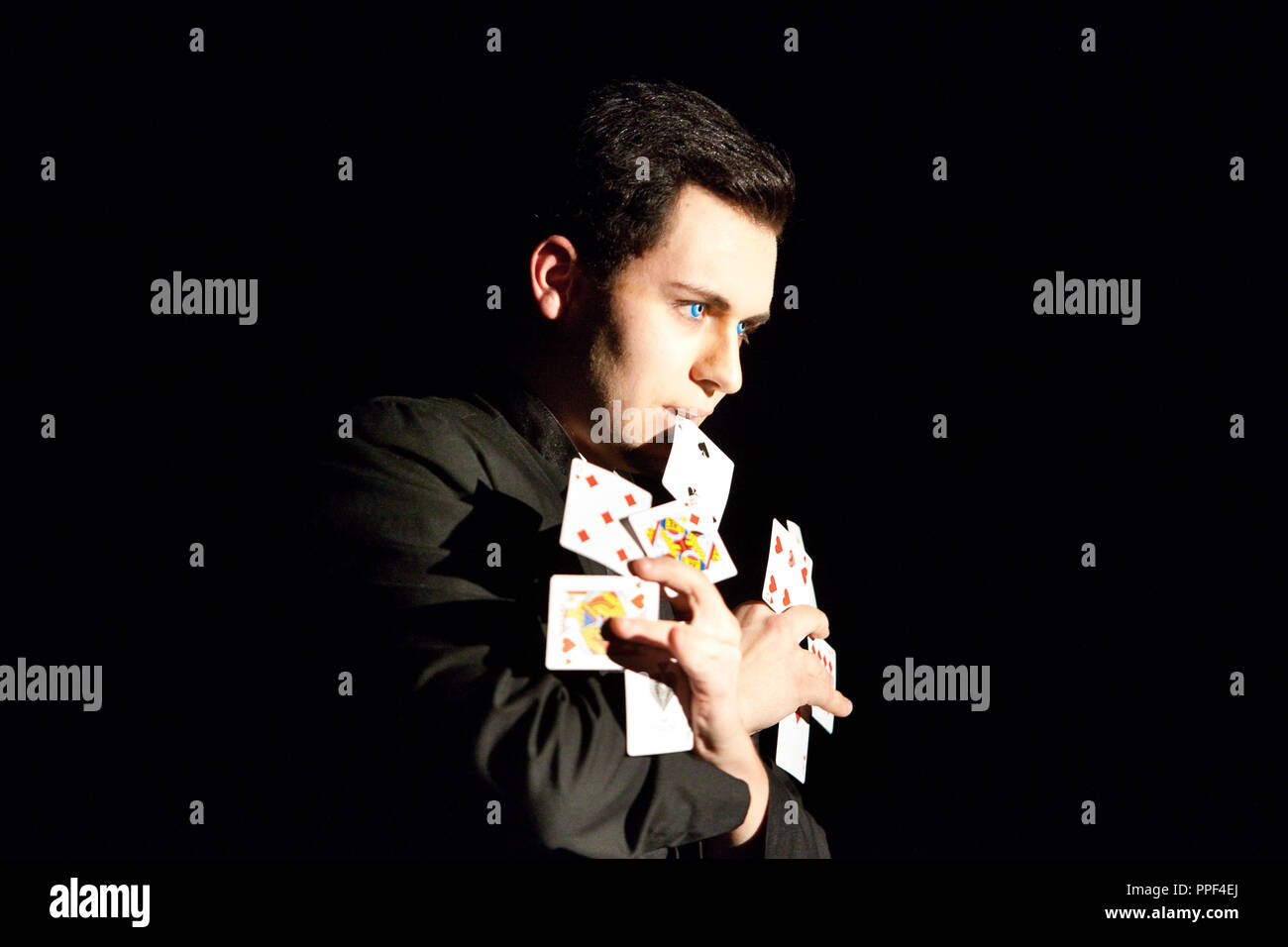 Magician Lukas Lehnertz as Luke Dimon performing a card trick at the ...