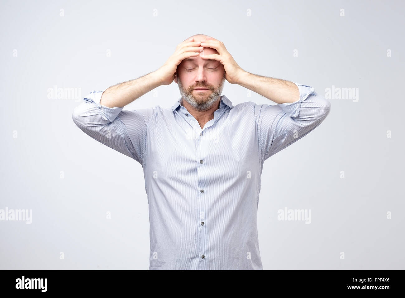 Studio portrait of upset worried sad, depressed, tired man with a ...