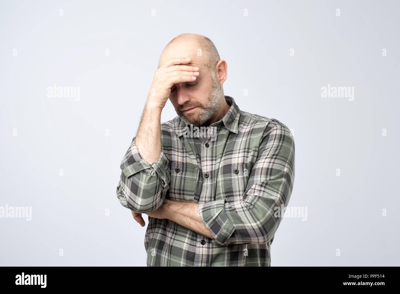 Studio portrait of upset worried sad, depressed, tired man with a ...