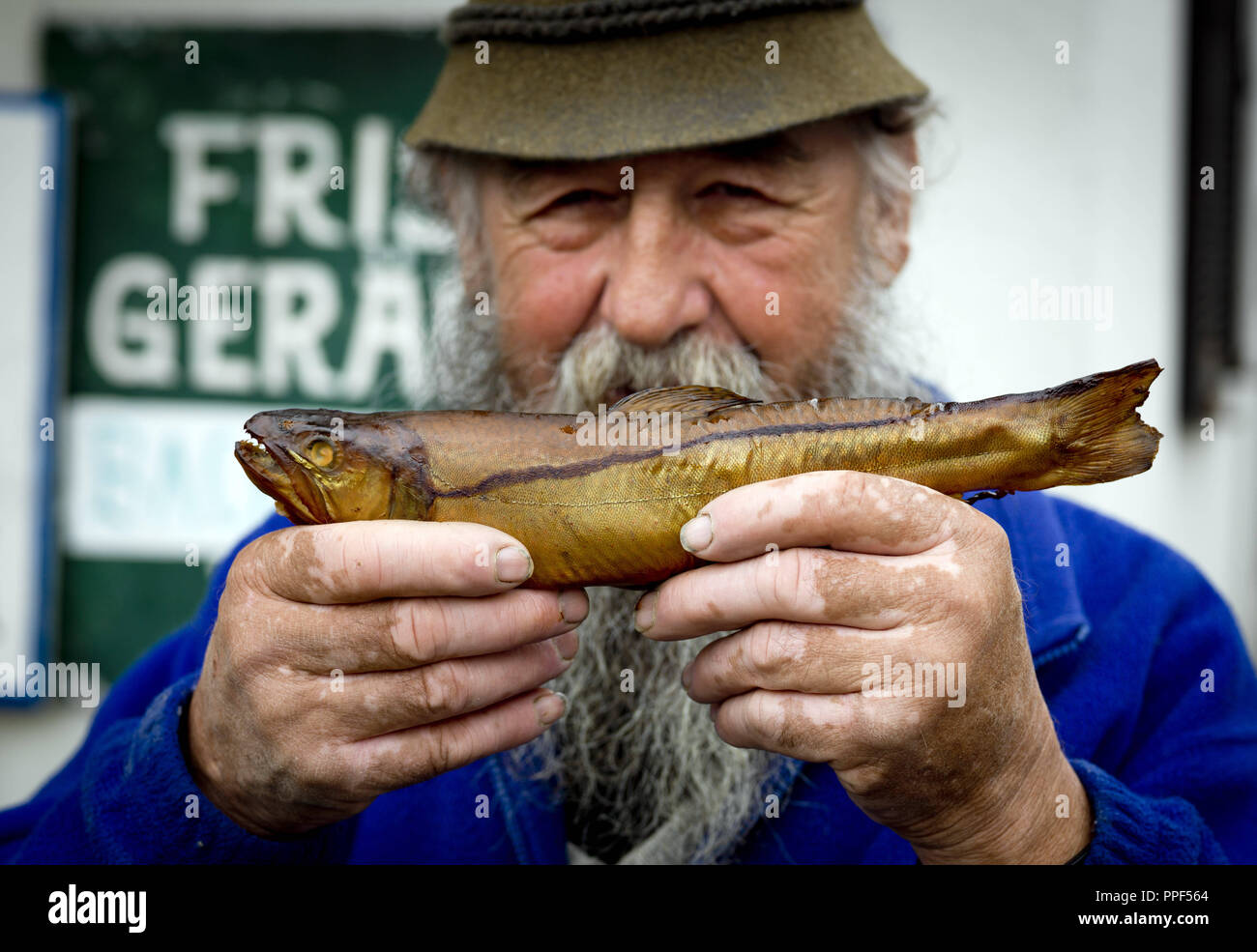 Simon Rauch, a fisherman on the Ammersee, with a smoked fish in front ...