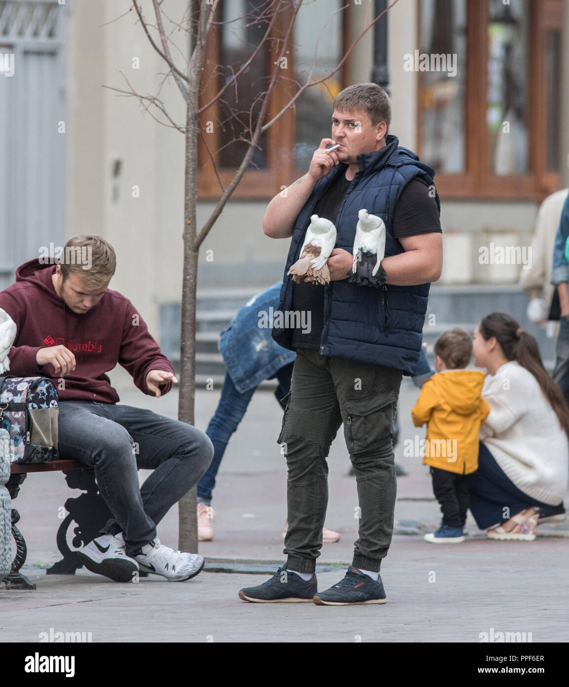 Kazan, Russia - 27 august 2018 - Man with hand pigeons is standing on ...