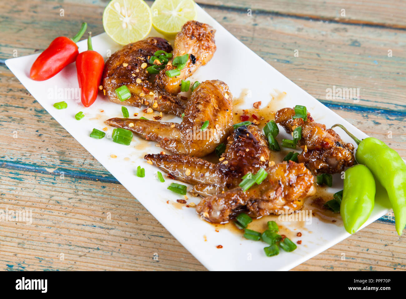 Spicy red chilli chicken wings Stock Photo - Alamy