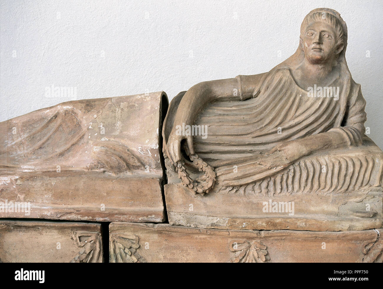 Etruscan sarcophagus depicting a female deceased reclining carrying a ...