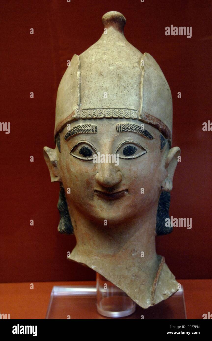 Head from a statue of a warrior with conical helmet. Terracotta. 625 ...