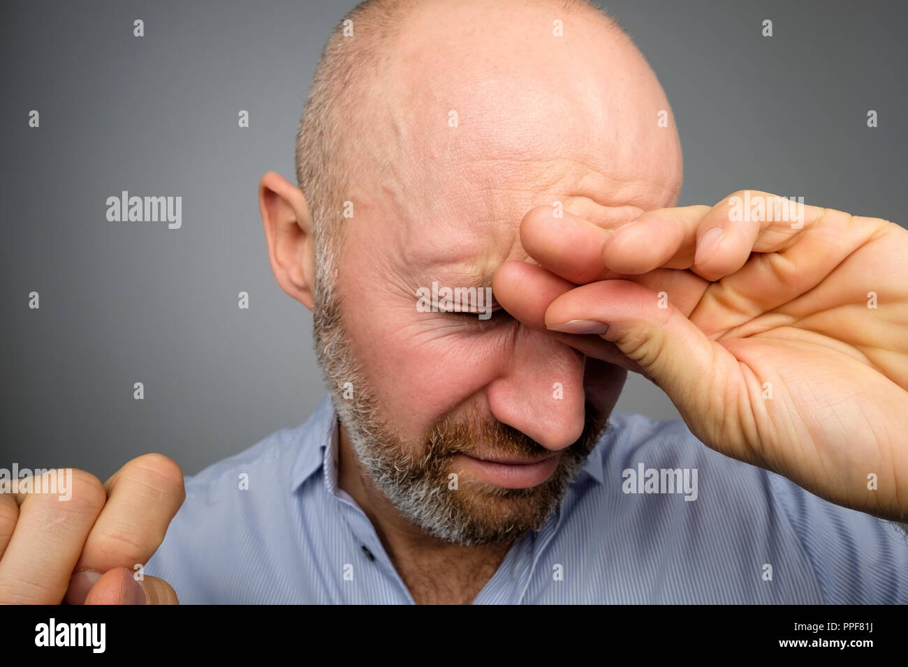 Good-looking caucasian man suffering from pain and eye pain isolated on ...