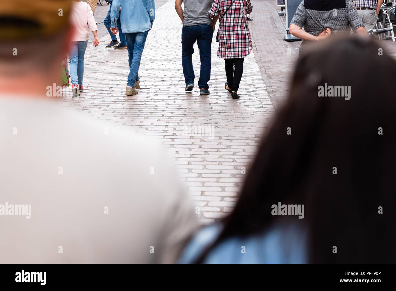 picture with body parts of people walking in the city on a shopping ...