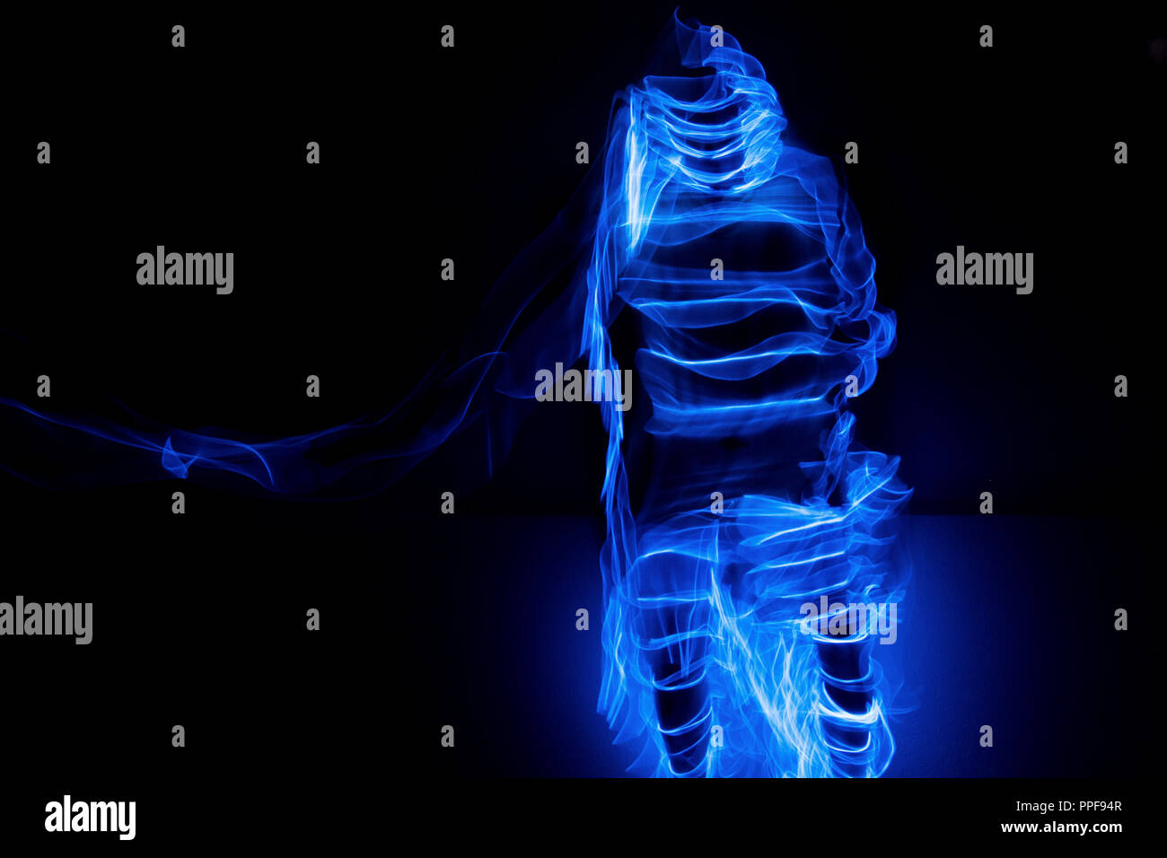 Long exposure photograph depicting a blue illuminated man Stock Photo ...