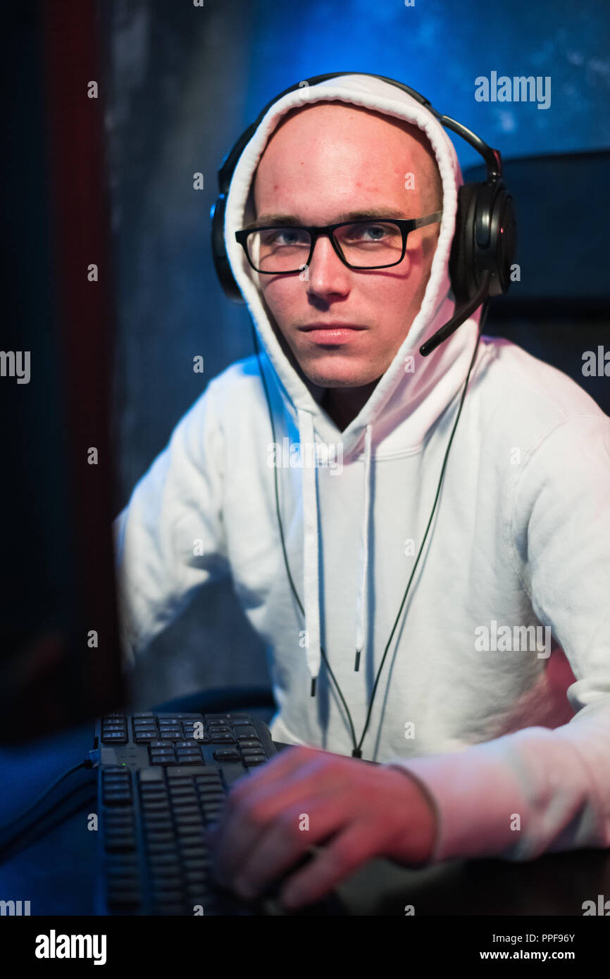 male hooded gamer playing online game on pc computer Stock Photo - Alamy