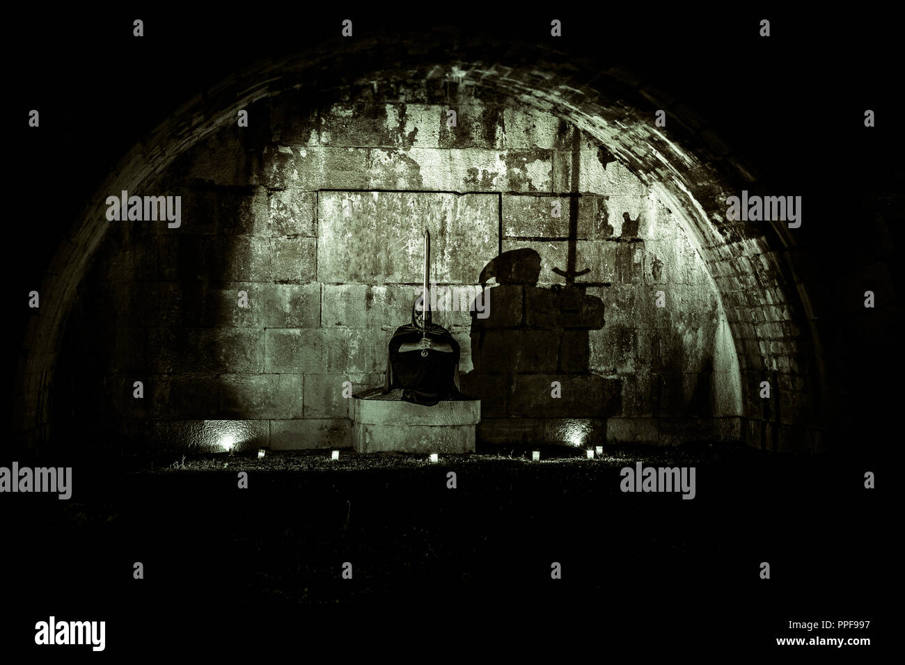Gothic scene of terror, playing with the shadows and under a stone arch ...