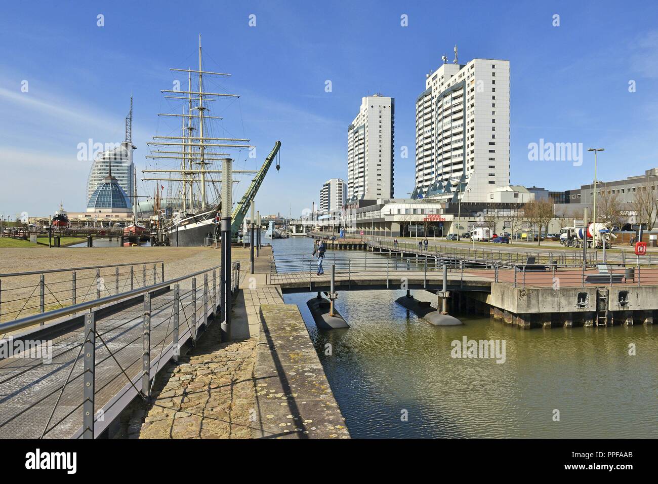 Shore by the old harbour with ships beside the white high-rise ...